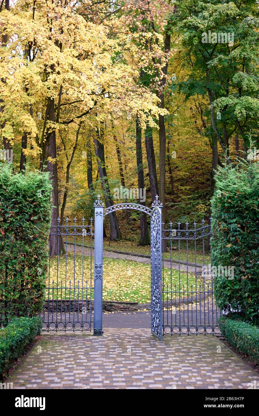 Opened steel park gate doors Stock Photo - Alamy