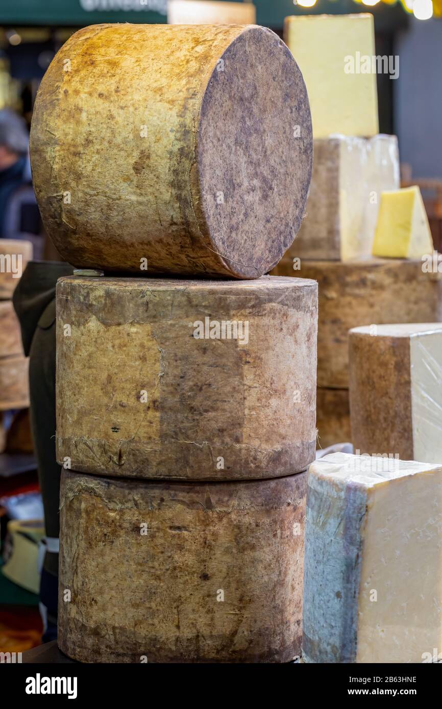 Stack of unpasteurised Cheddar cheese wheels on a market stall Stock ...
