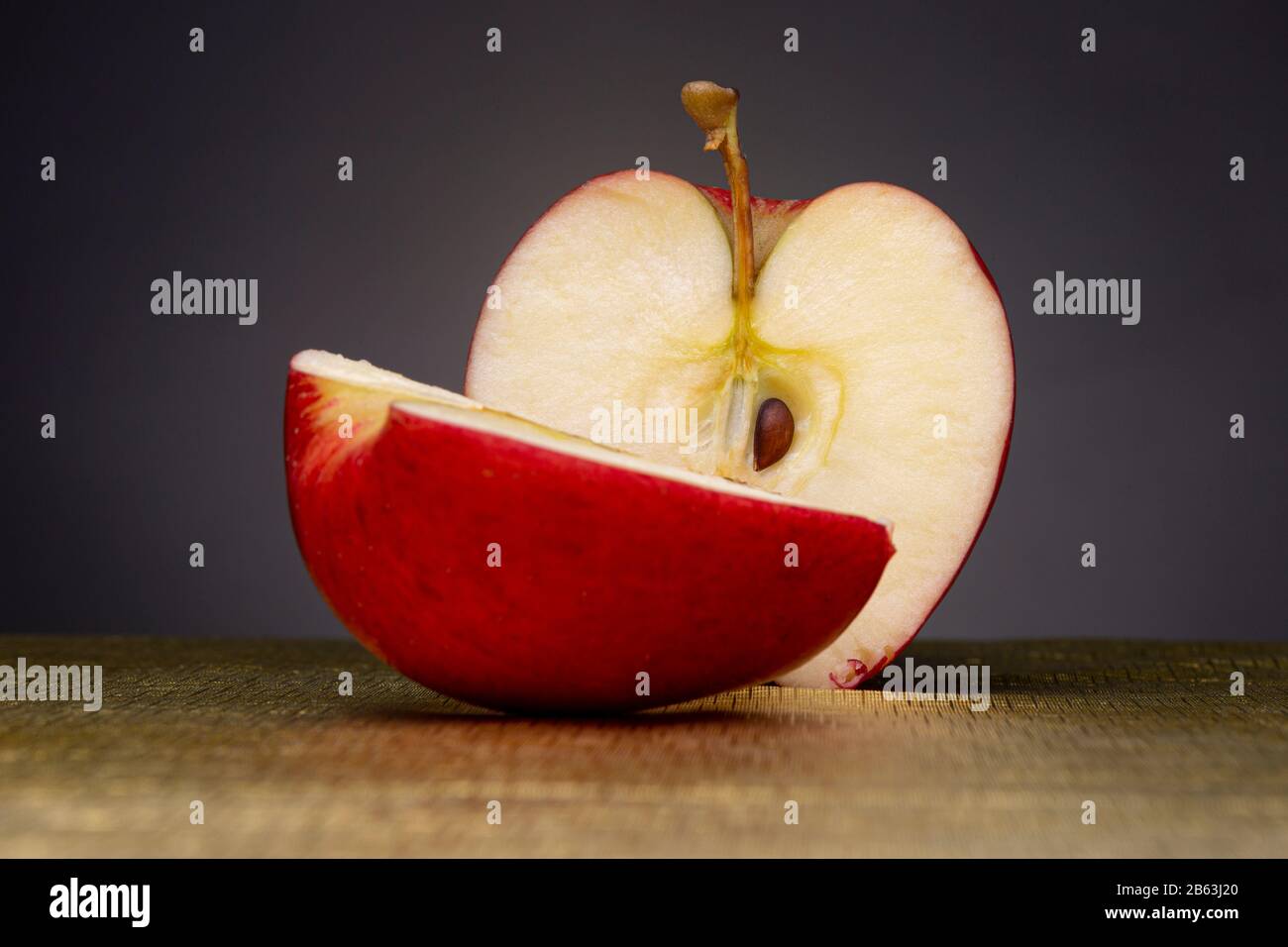 Vibrant bright red apple against dark studio background Stock Photo - Alamy
