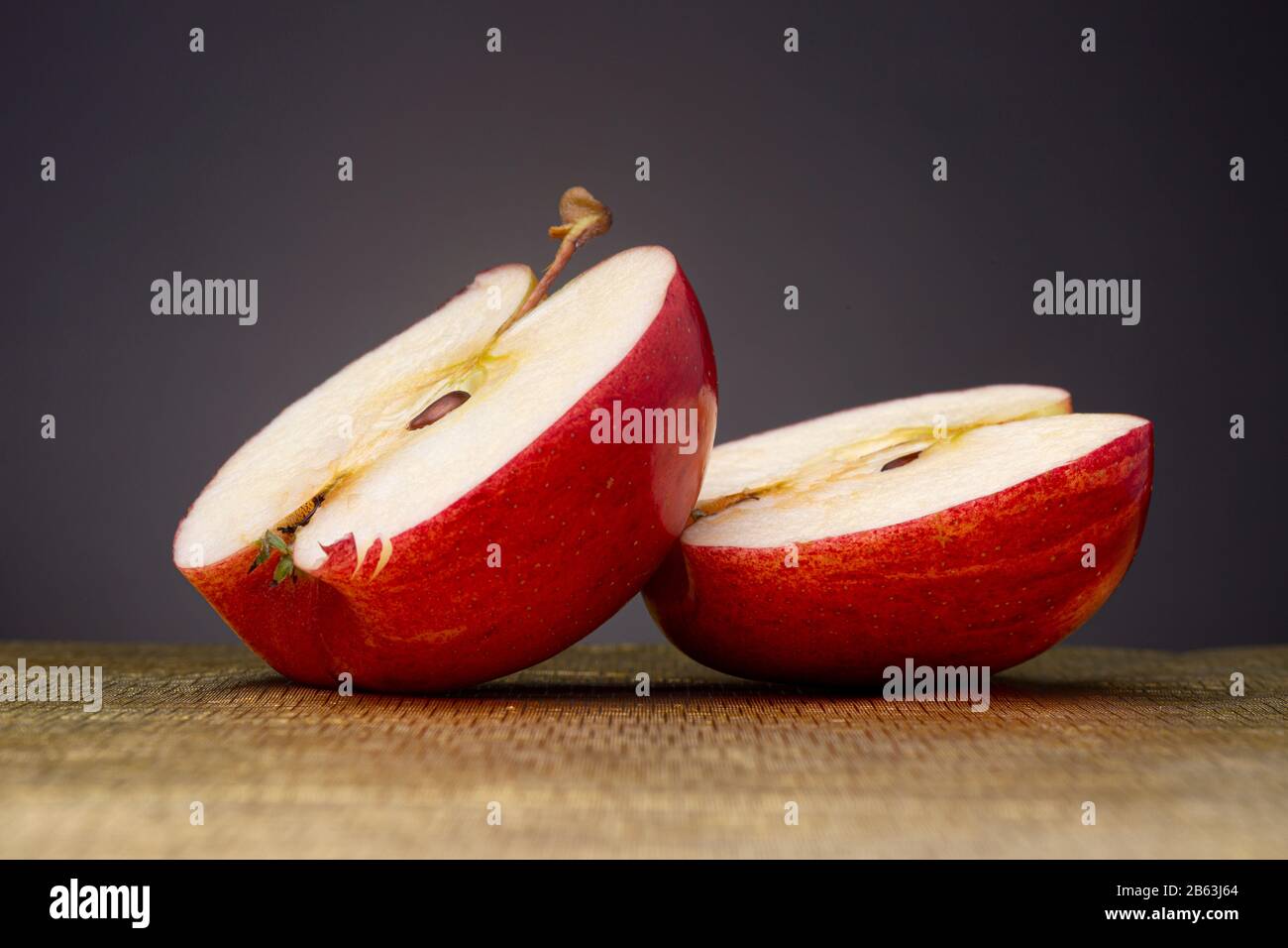 Vibrant bright red apple against dark studio background Stock Photo - Alamy