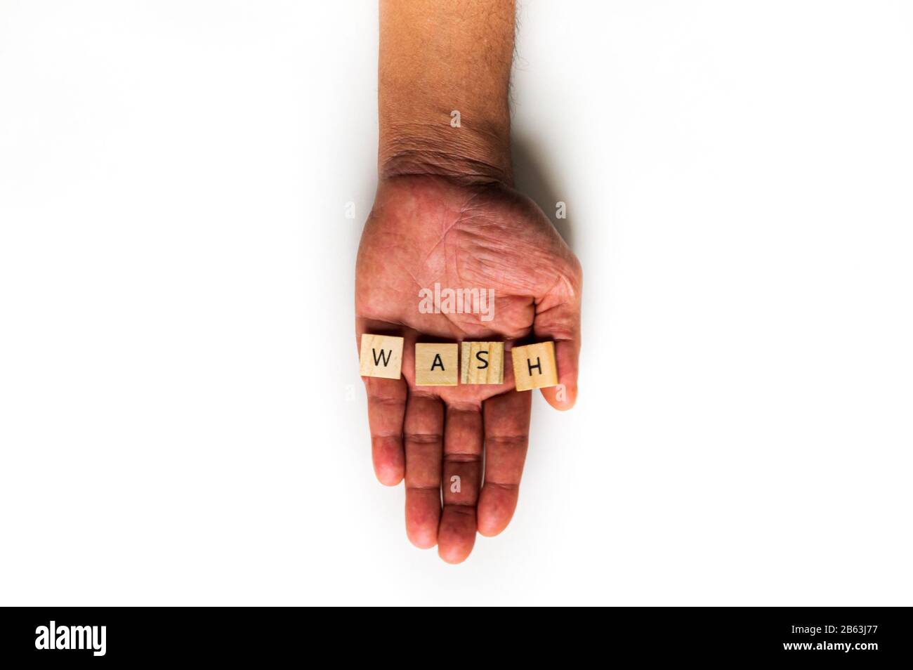 An isolated hand displays the message "WASH". Handwashing concept Stock ...