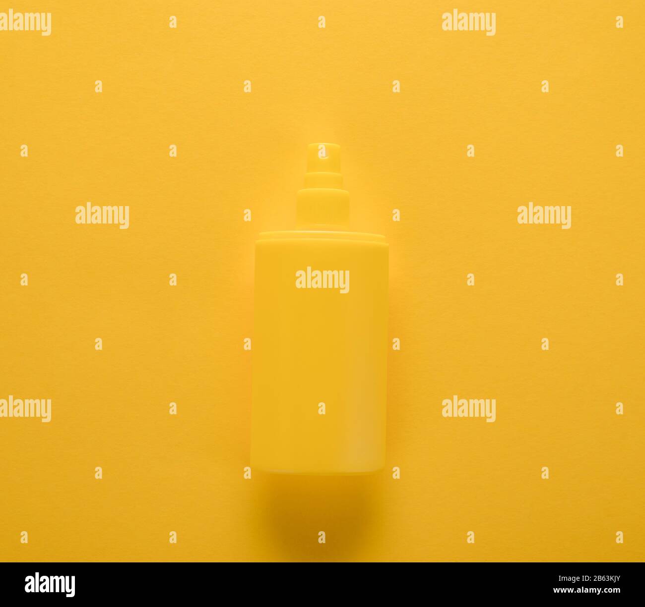Sunscreen spray on yellow background Stock Photo - Alamy