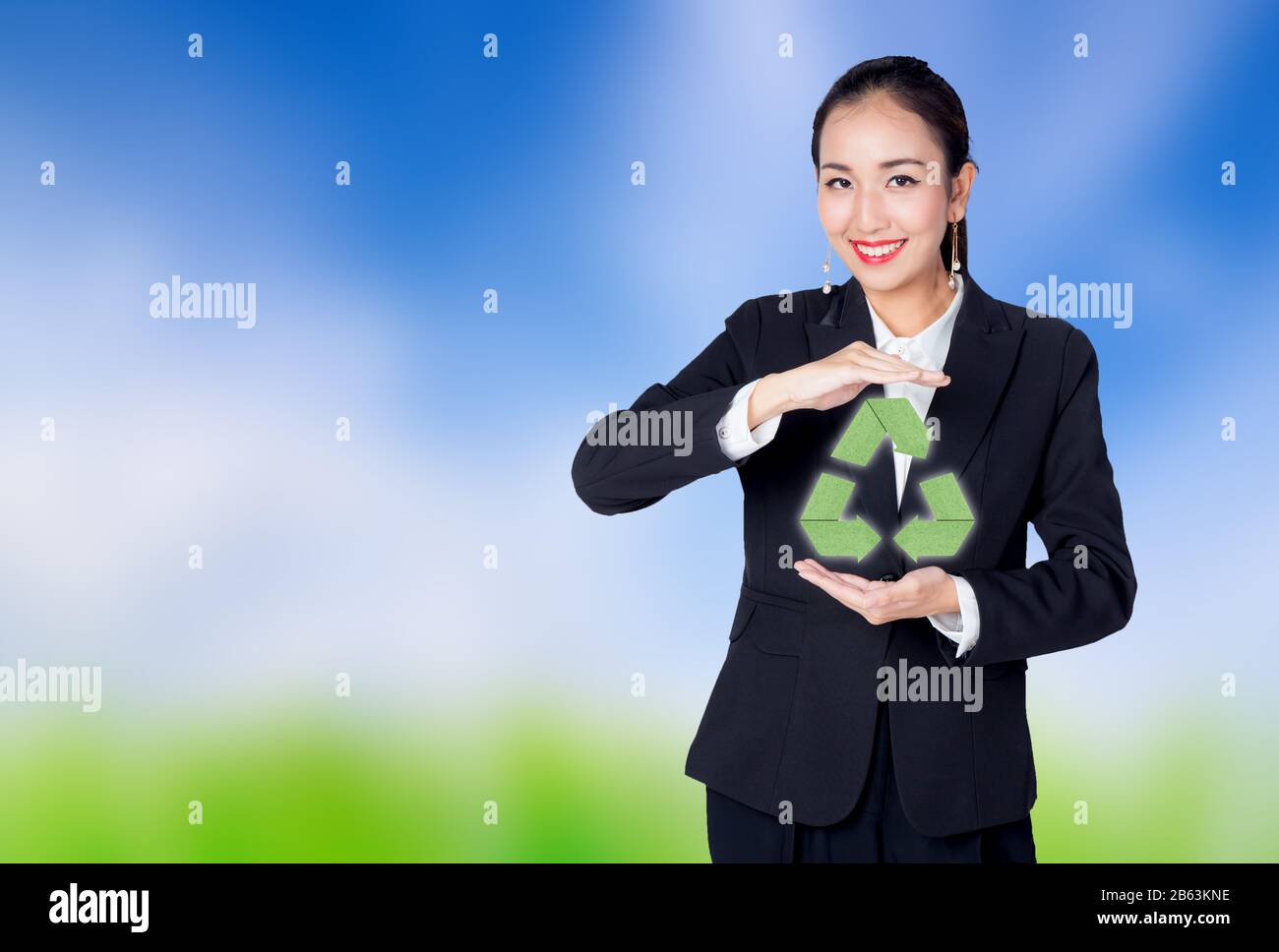 woman holding the recycle icon, symbol for recycling on nature ...