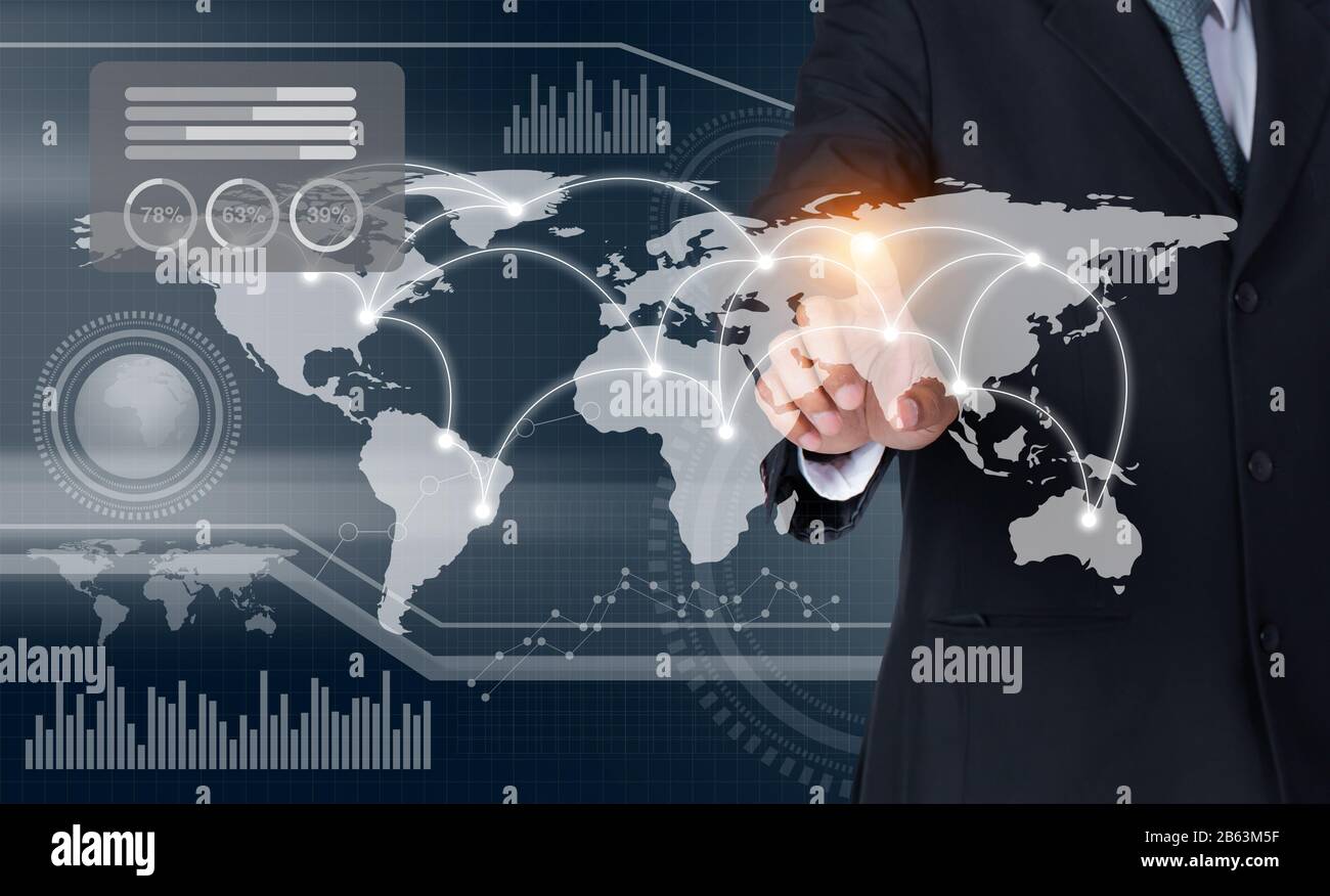 Businessman touching world map and graph on screen with his finger ...