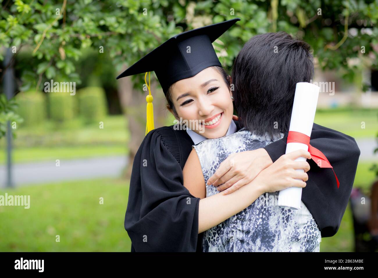 young female graduate hugging her friend at graduation ceremony Stock ...