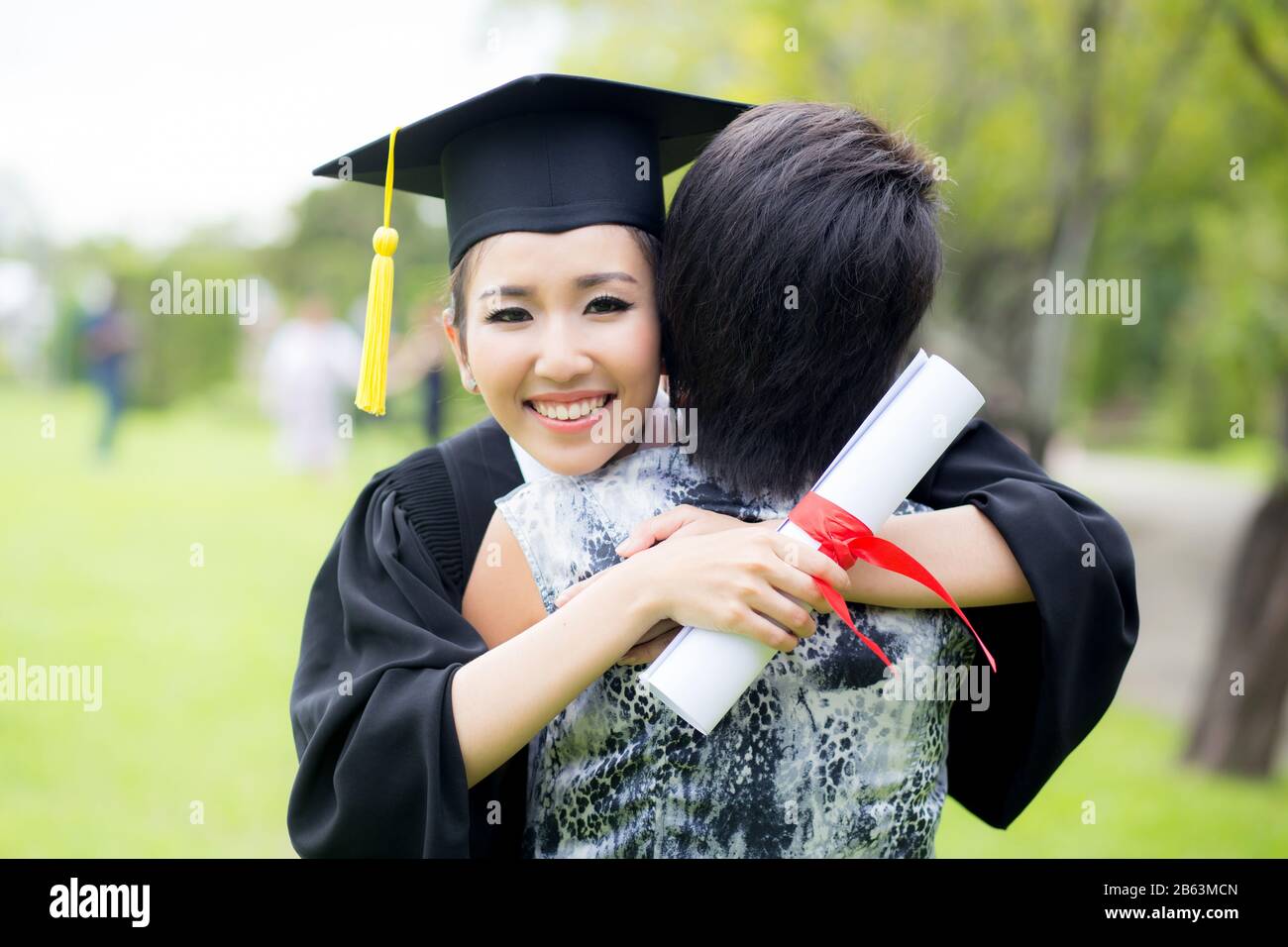 young female graduate hugging her friend at graduation ceremony Stock ...