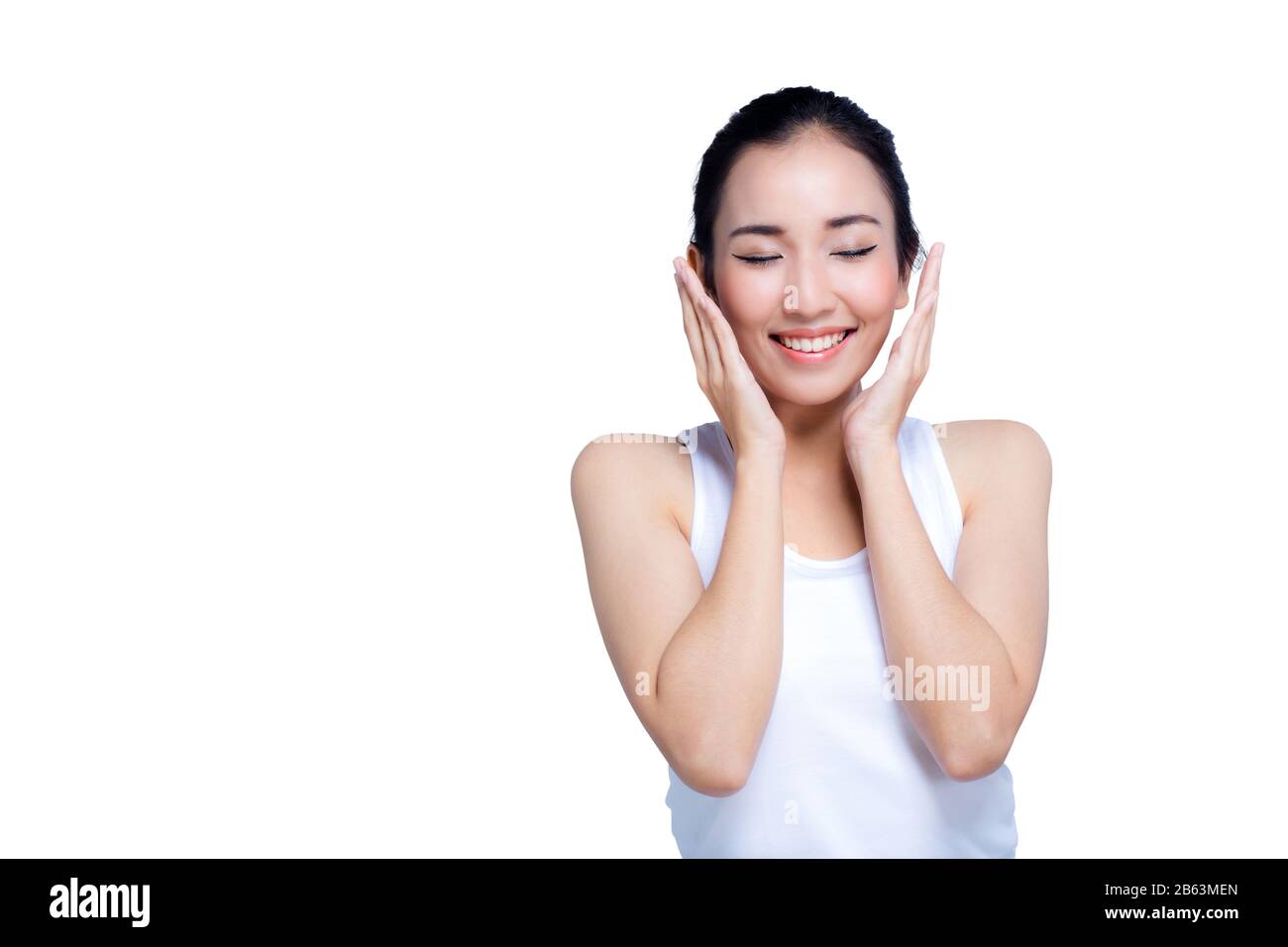 Beauty model woman with hands on cheeks looking at camera with a smile ...