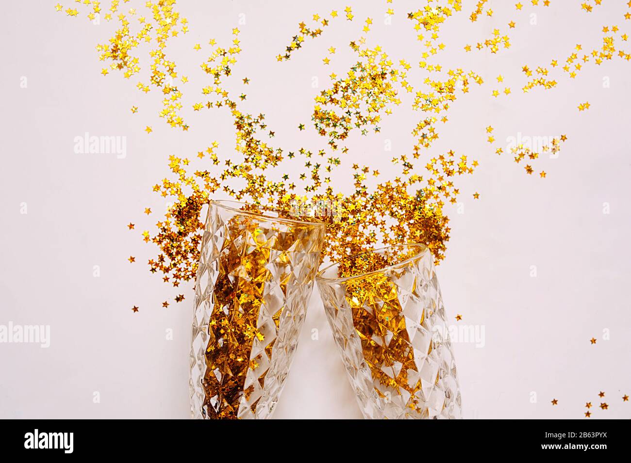 Splashes of gold spangles of stars from a glass figurative glass on a ...