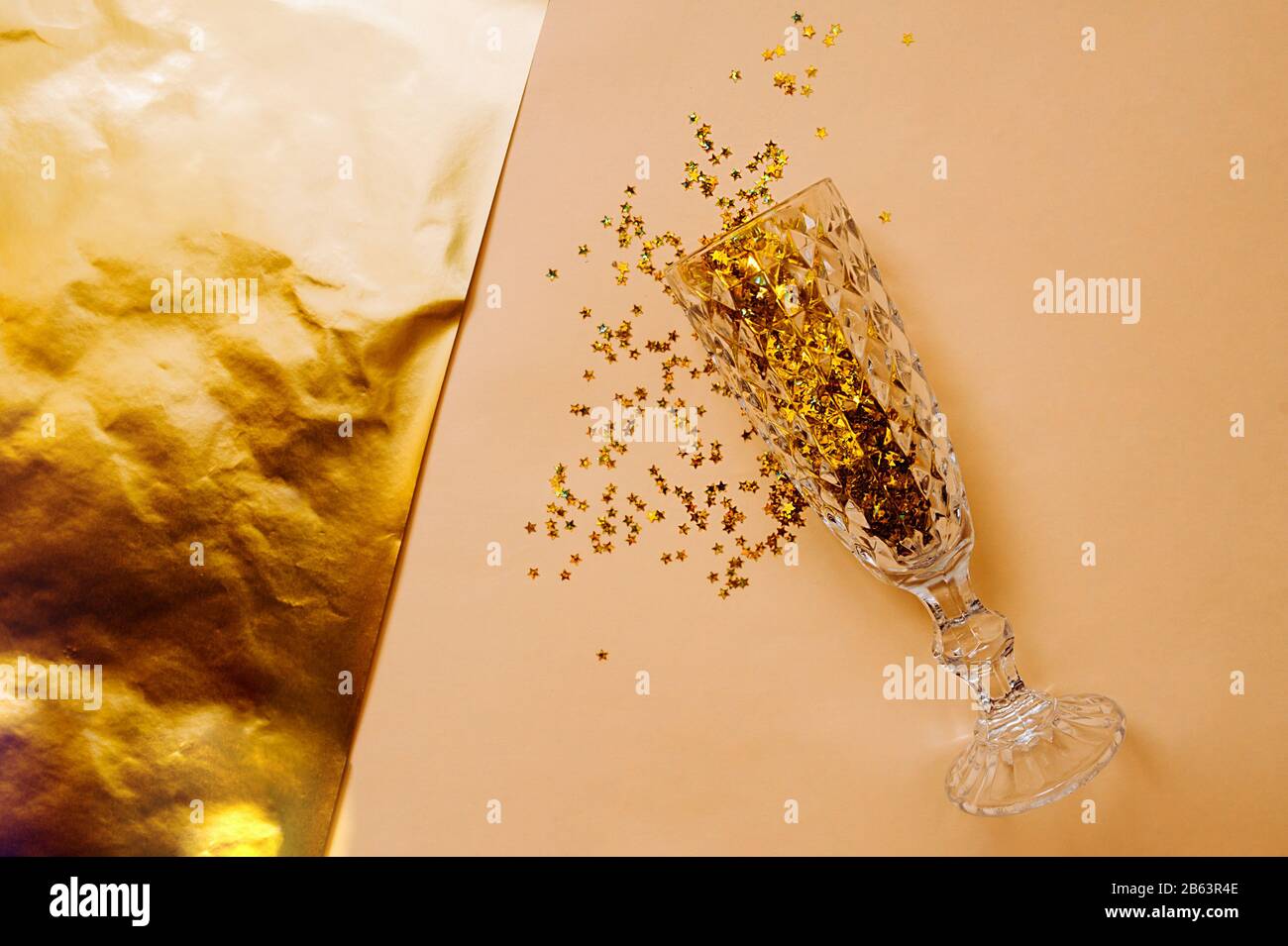 Splashes of gold spangles of stars from a glass figurative glass on a ...