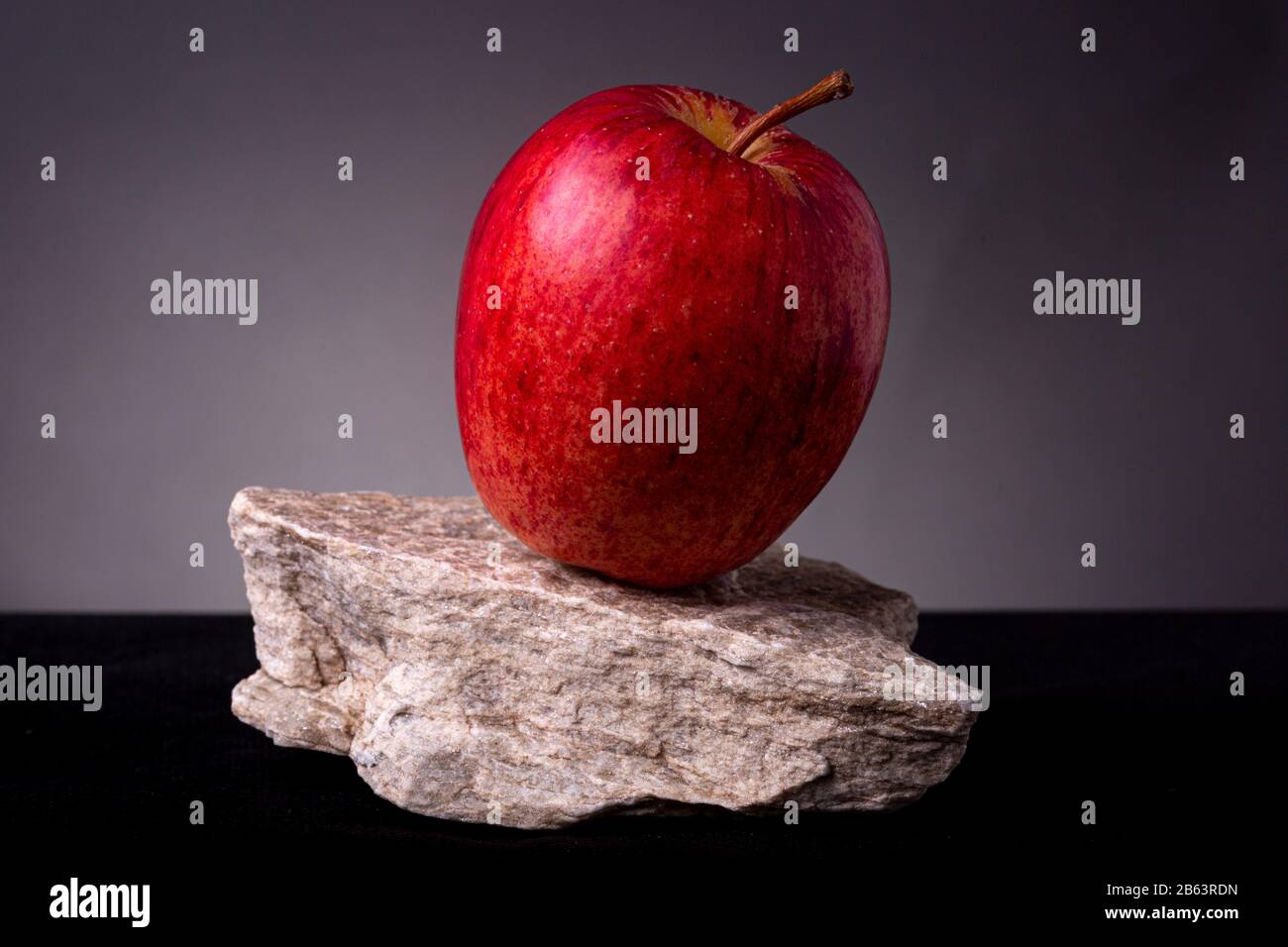 Vibrant bright red apple against dark studio background Stock Photo - Alamy