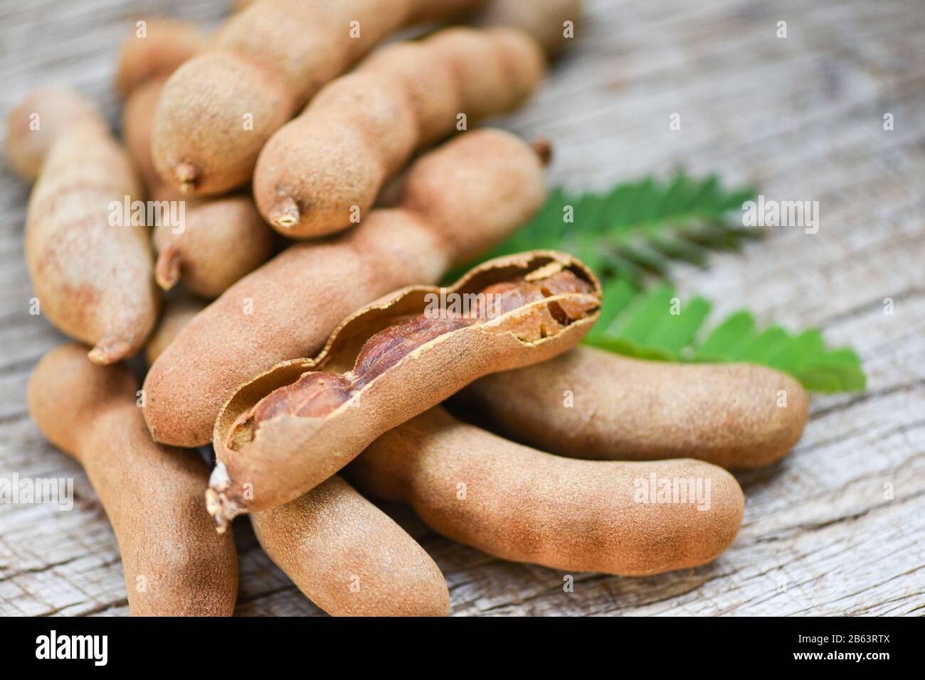 Tamarind and leaves tropical fruit / Sweet tamarind on wooden ...