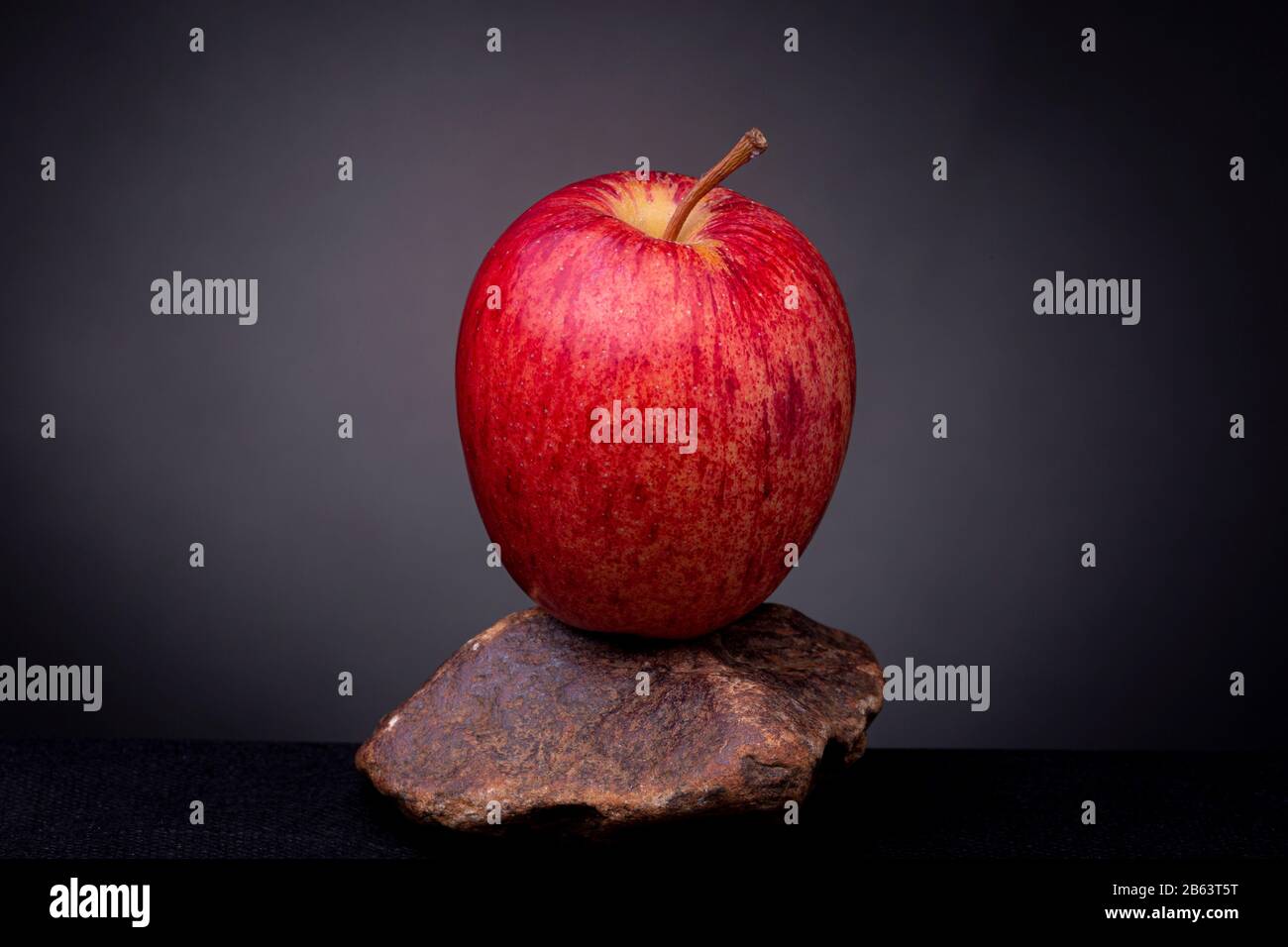 Vibrant bright red apple against dark studio background Stock Photo - Alamy