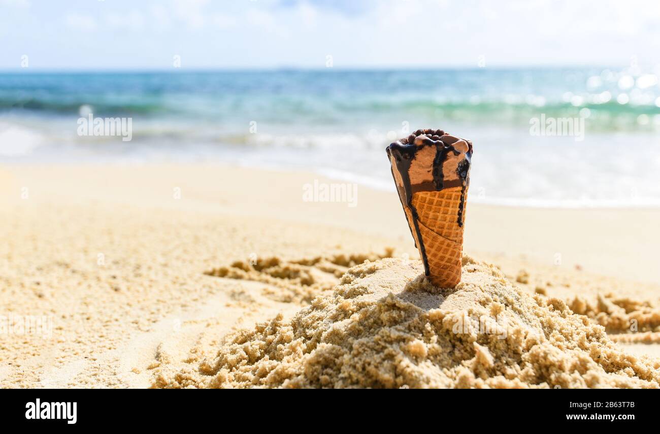 Ice cream cone on sand beach background / Melting ice cream on beach ...