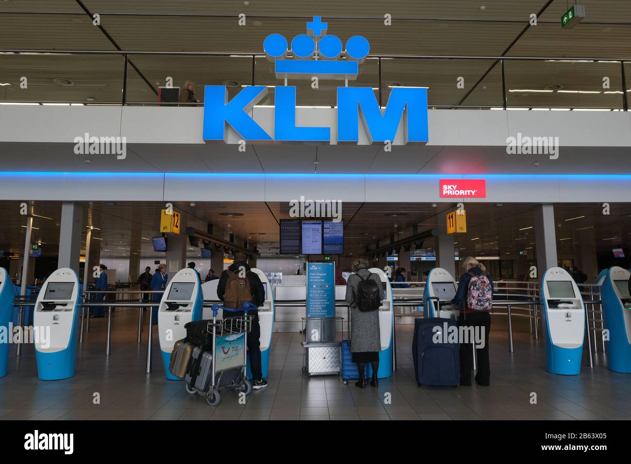 Travelers check-in on automated machines of KLM Royal Dutch Airlines at ...