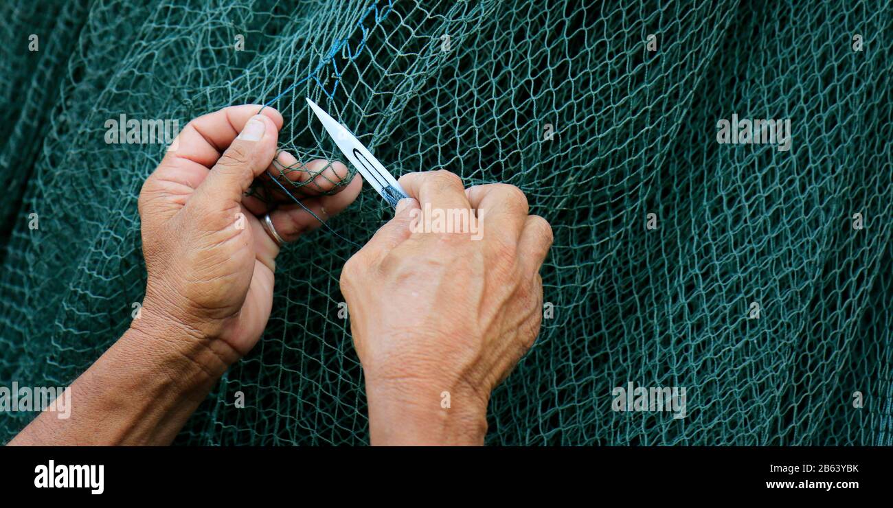 Fish net repair hi-res stock photography and images - Alamy