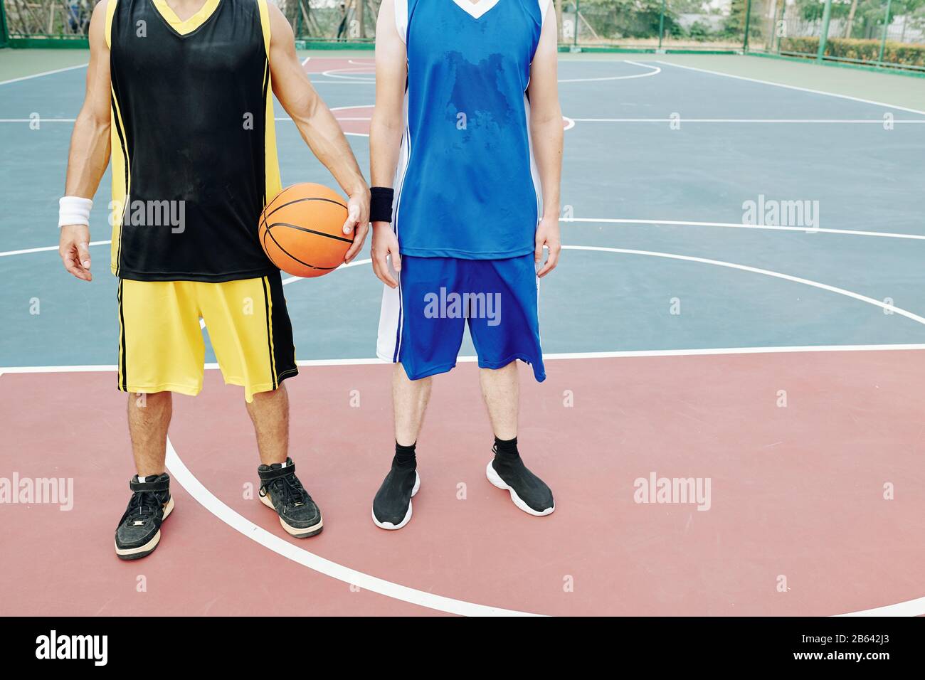 Sweaty young sportsmen tired after playing basketball on outdoor court ...