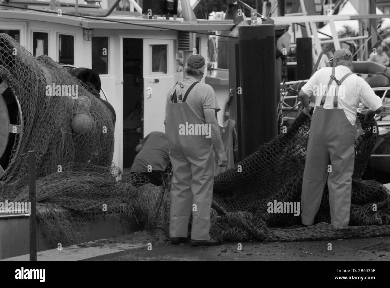Two fishermen net fish Black and White Stock Photos & Images - Alamy