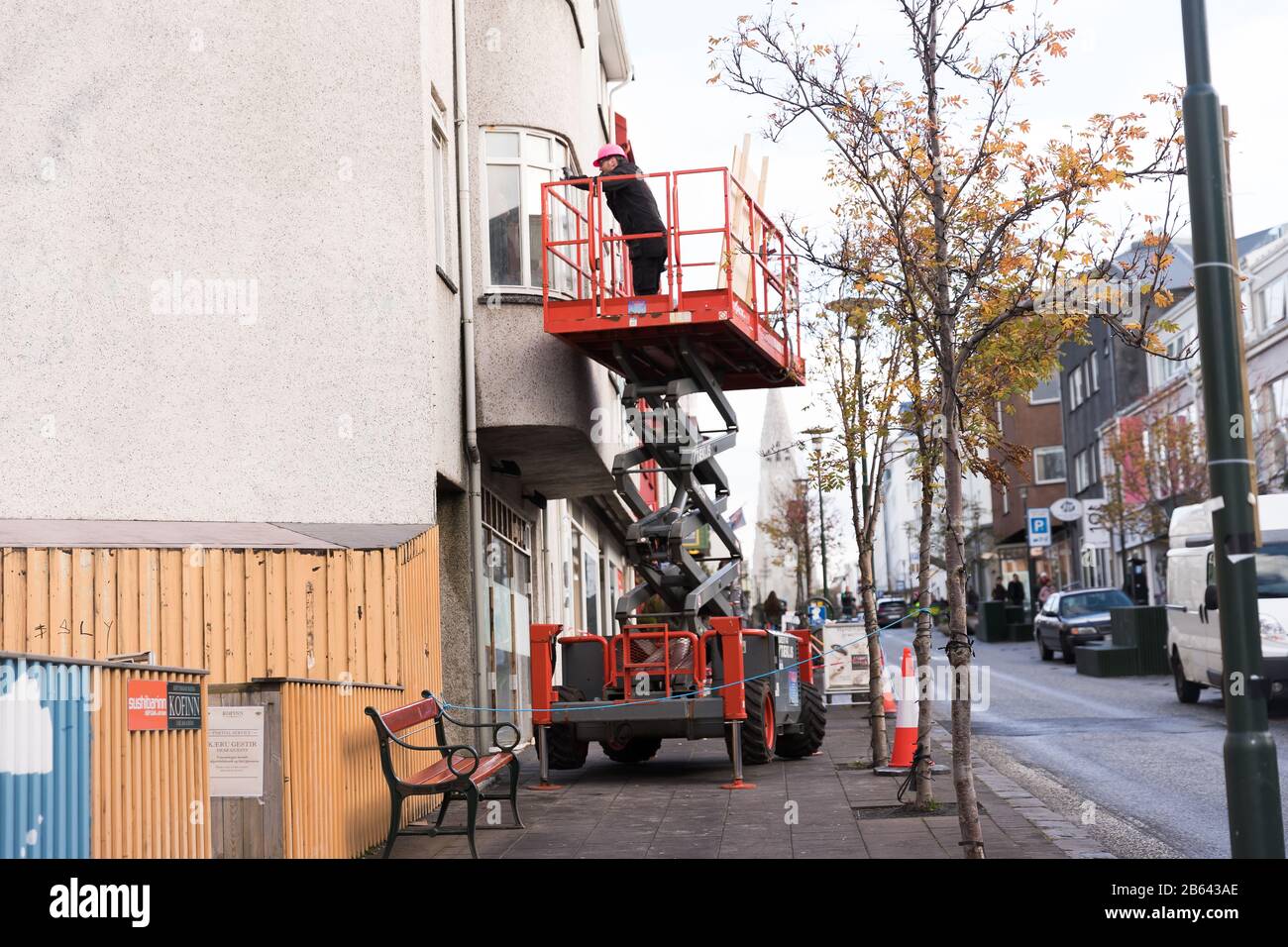 Construction people at work lifted in a cradle Stock Photo - Alamy
