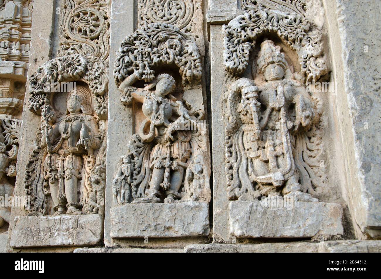 Carved idols on the outer wall of Shantinatha Basadi, near ...