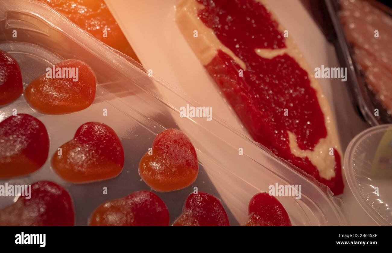 Skin pack or vacuum skin packaging. Meat and gummy candy in thin ...