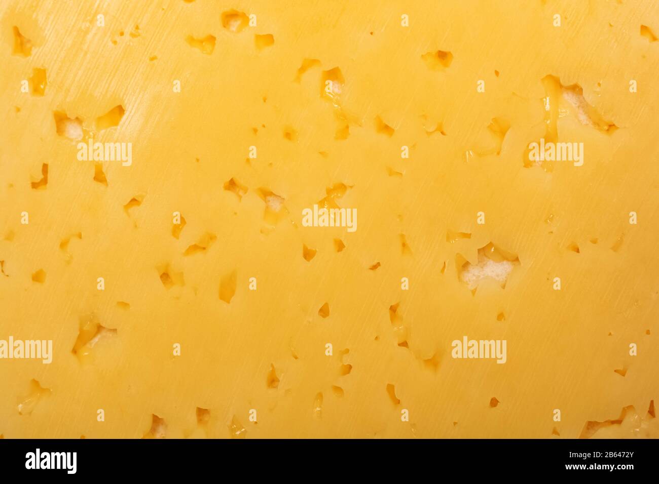 Yellow cheese hole texture or abstract background Stock Photo - Alamy