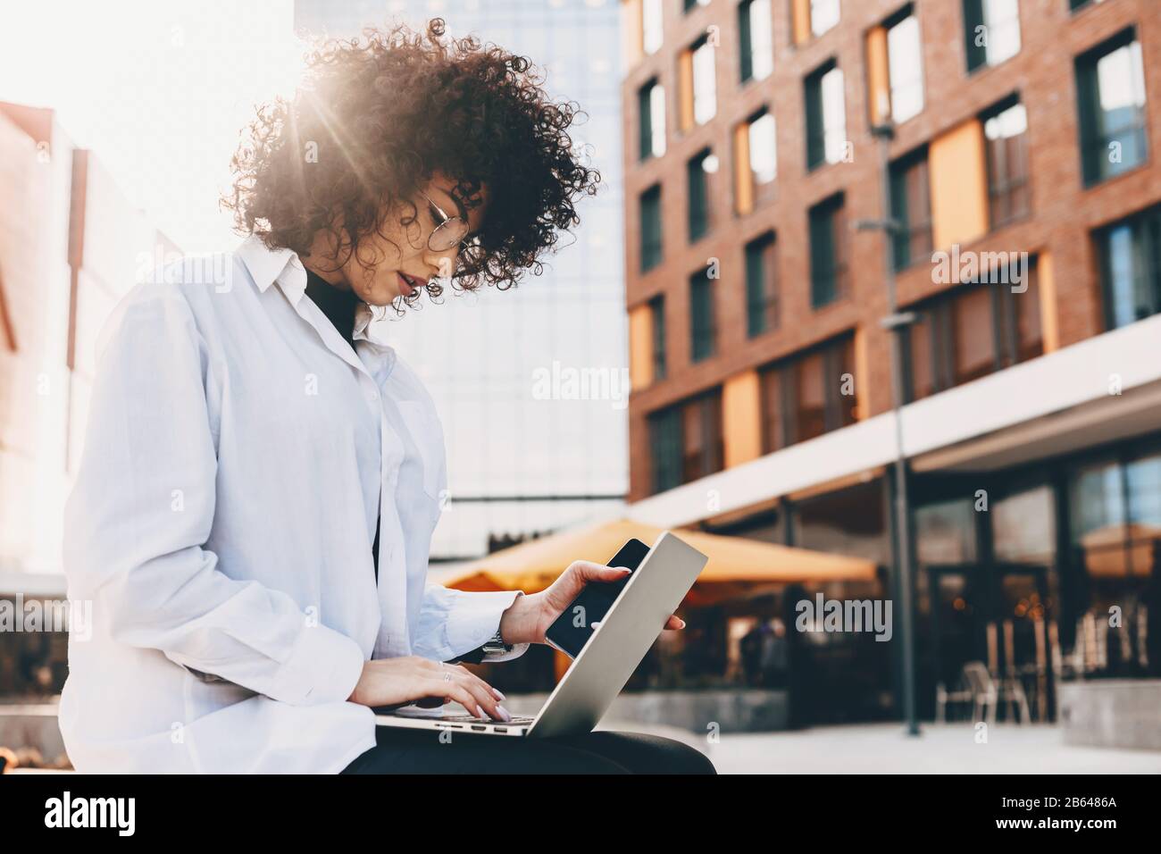 Close up photo of a busy caucasian it worker sitting on a bench and ...