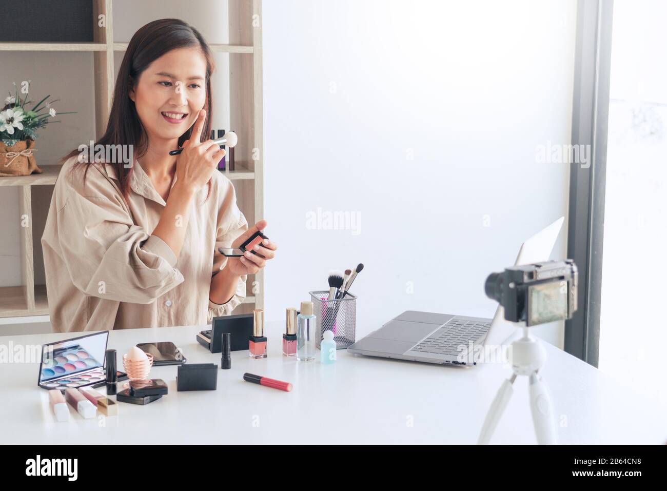 Makeup Beauty fashion blogger recording video presenting cosmetics at ...