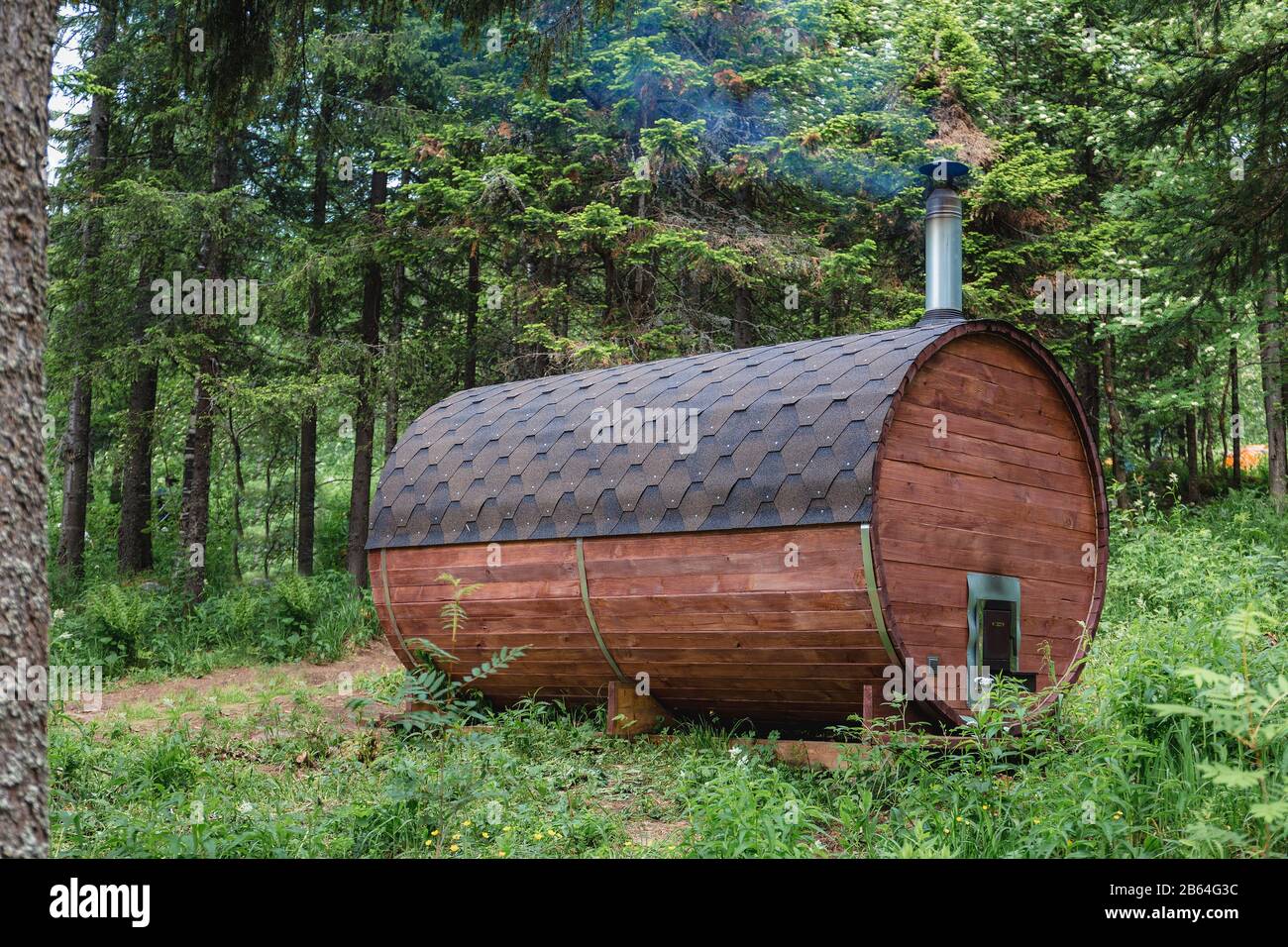 Unusual wooden sauna in forest. Bathhouse near the lake in summer Stock ...