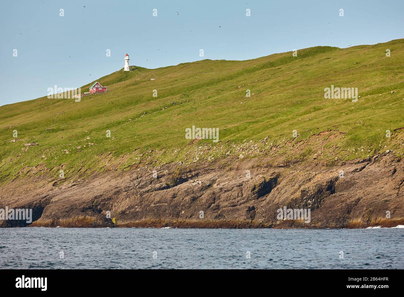 Mykines lighthouse and cliffs on Faroe islands. Hiking landmark ...