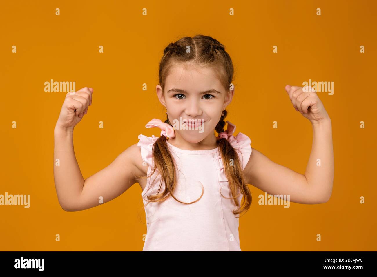 angry little child girl in dress raising fist frustrated and furious ...