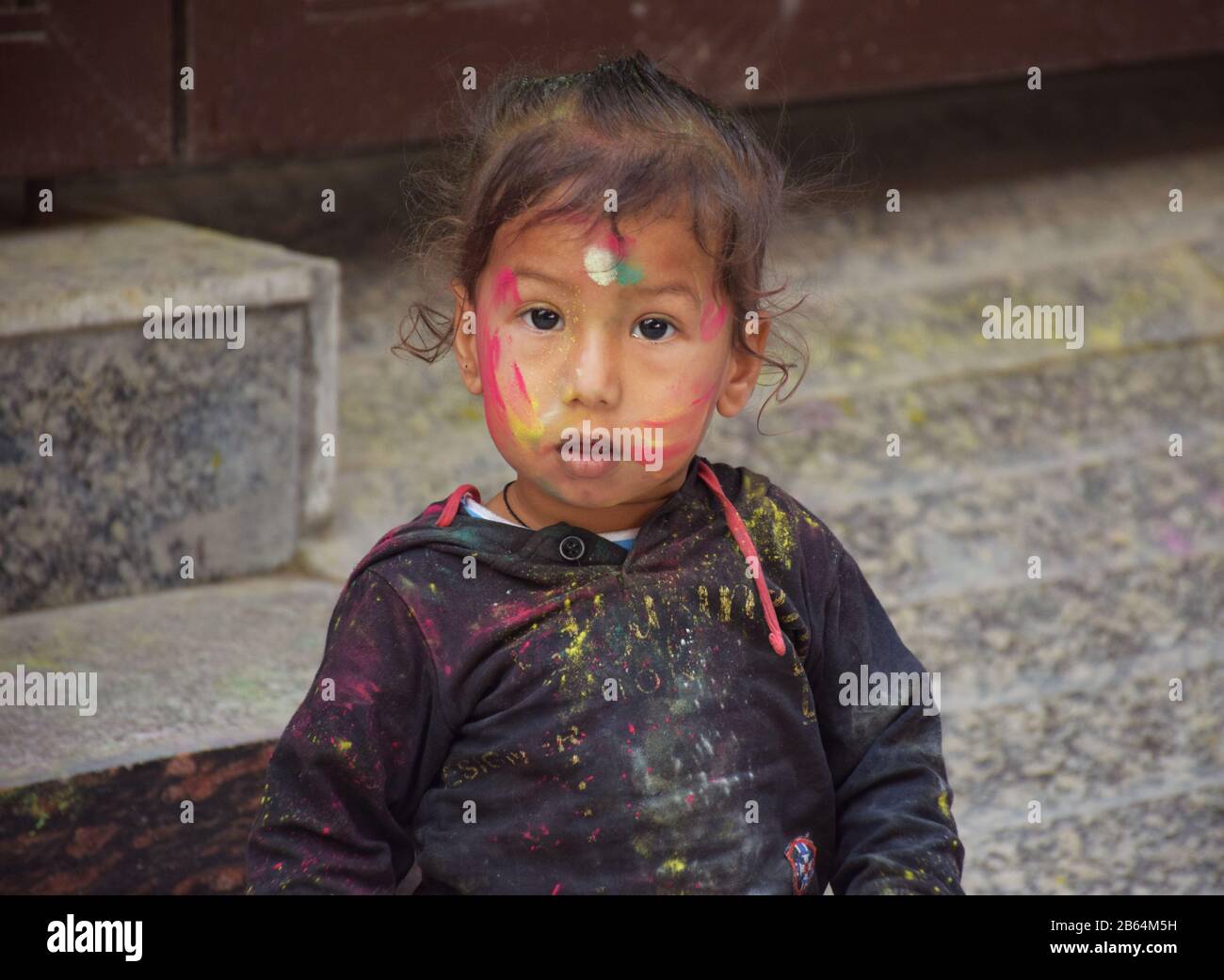 A kid celebrating Holi or playing holi in India Stock Photo - Alamy