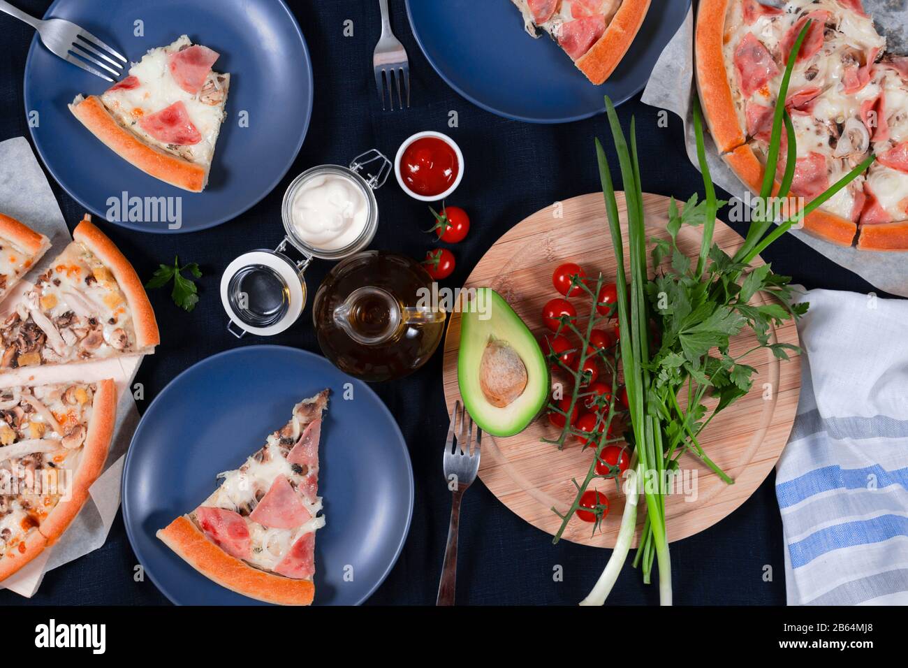 Table served full of delicious golden brown crust pizza, sauces and ...