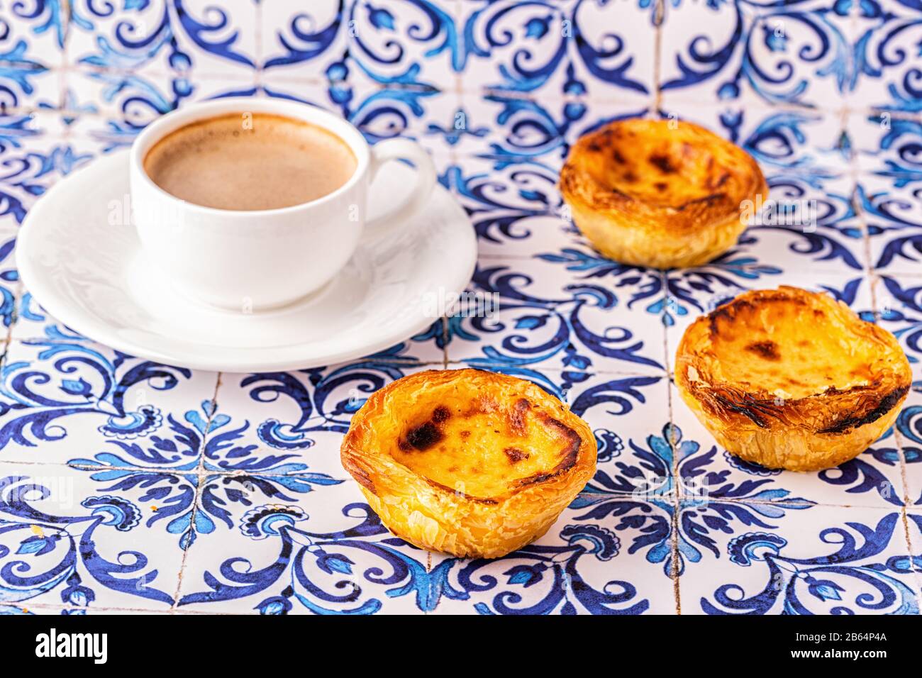 Egg tart, traditional Portuguese dessert, pastel de nata. Azulejo tile ...