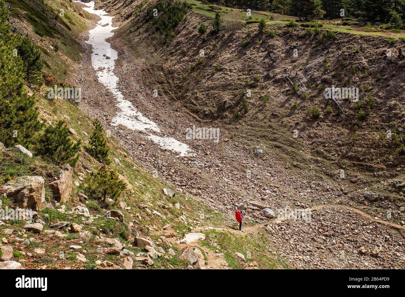 Man walking between red rocks hi-res stock photography and images - Alamy