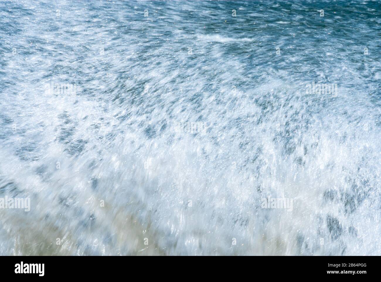Waves hit the hard surface of concrete wall and splashing sea water ...