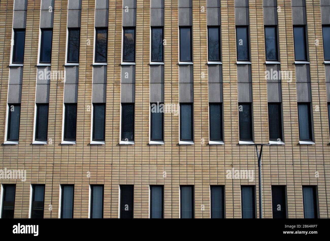 Facade of office building with narrow windows Stock Photo - Alamy