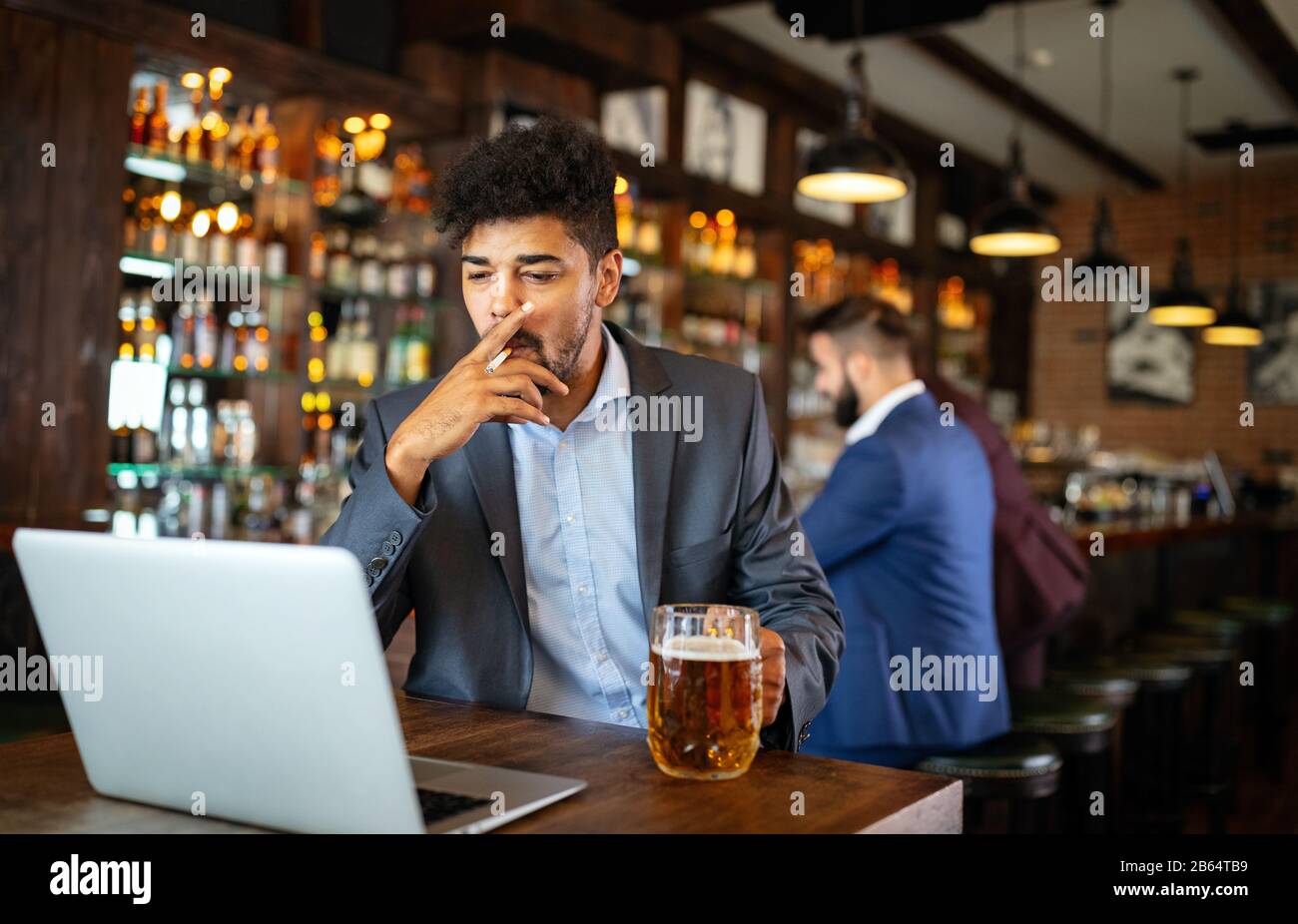 People and bad habits concept. Man drinking beer and smoking cigarette ...