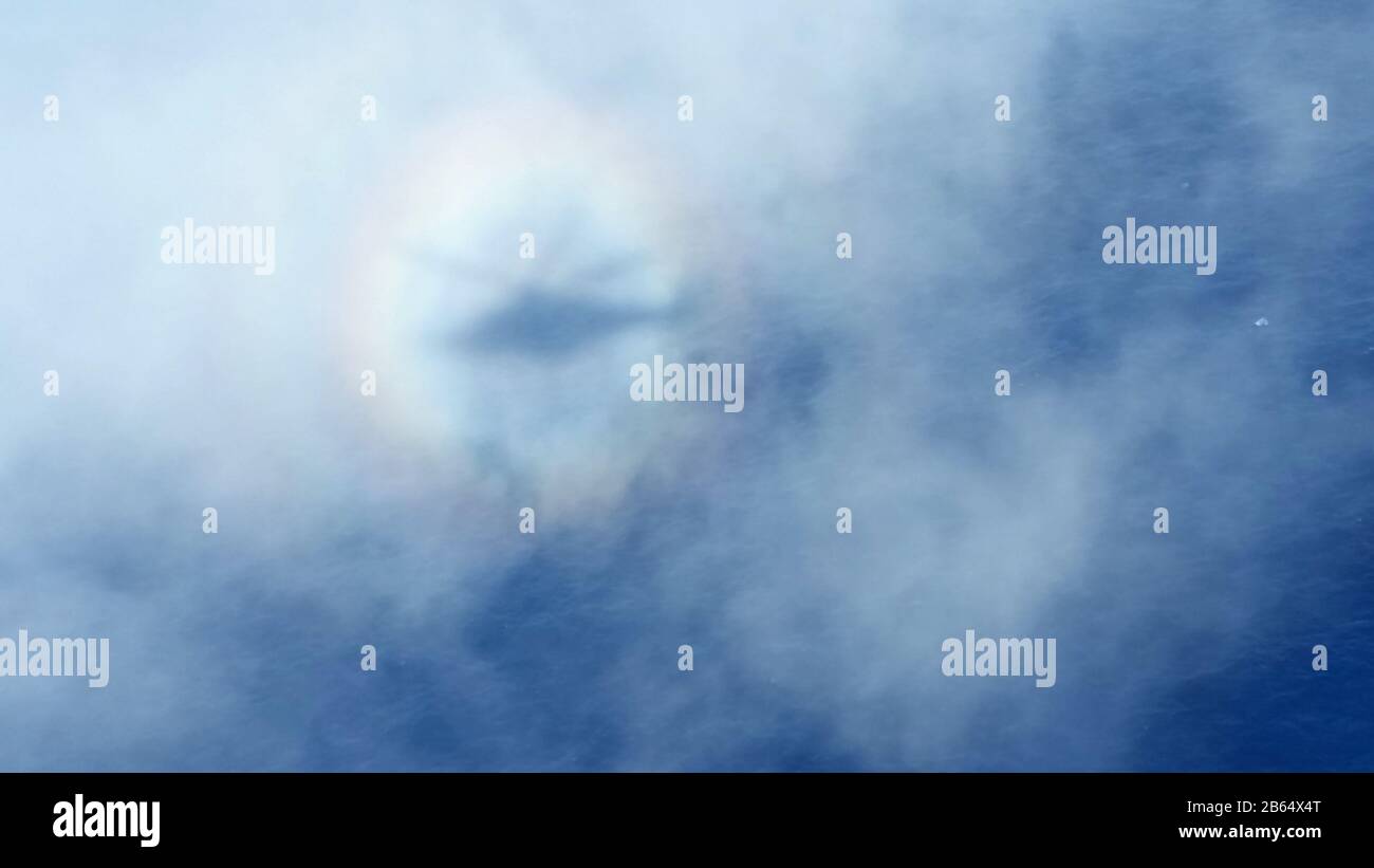 Silhouette helicopter in the cloud. Helicopter shadow with a rainbow ...