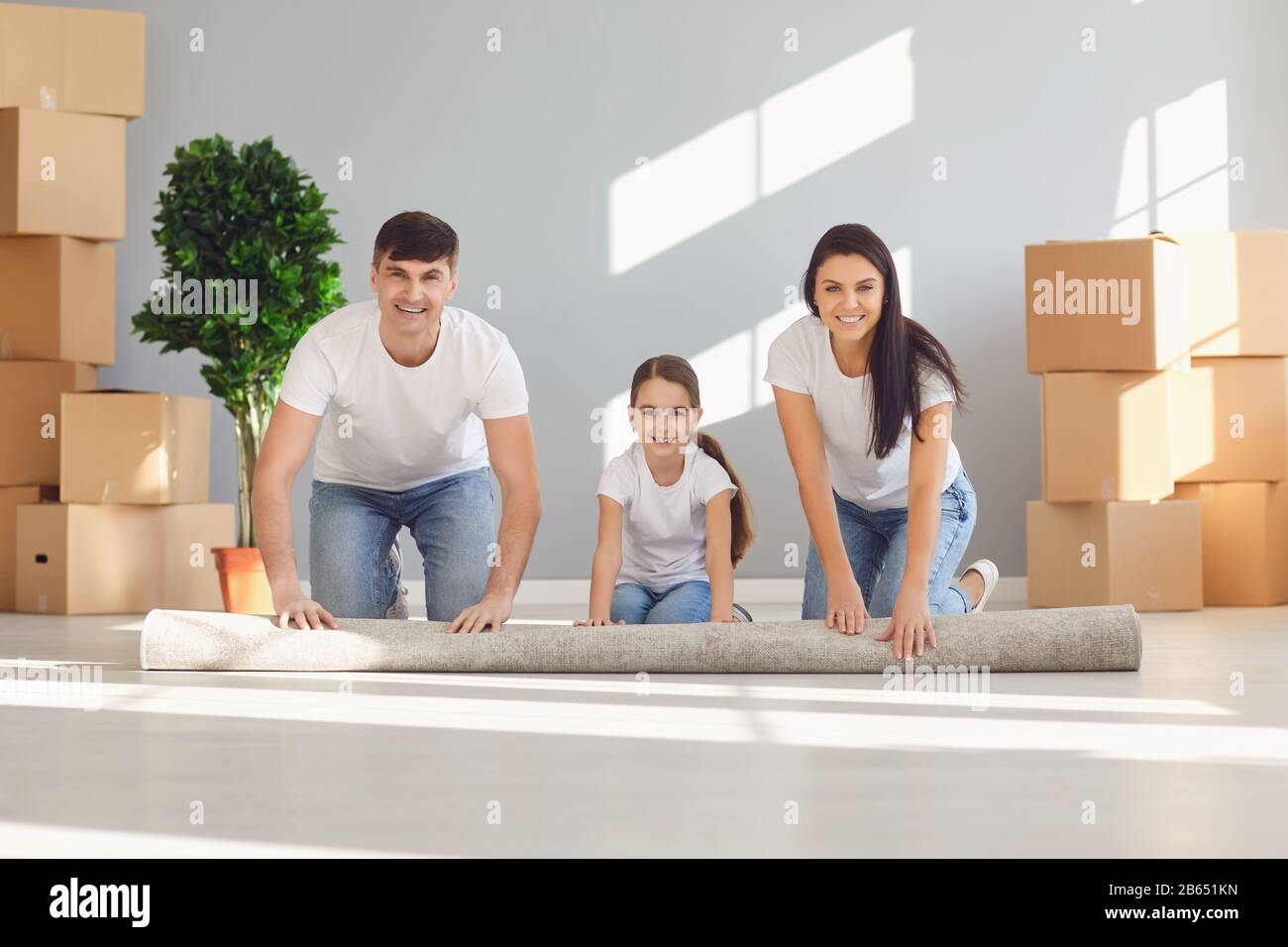 Happy family with children moving in a new apartment house Stock Photo ...