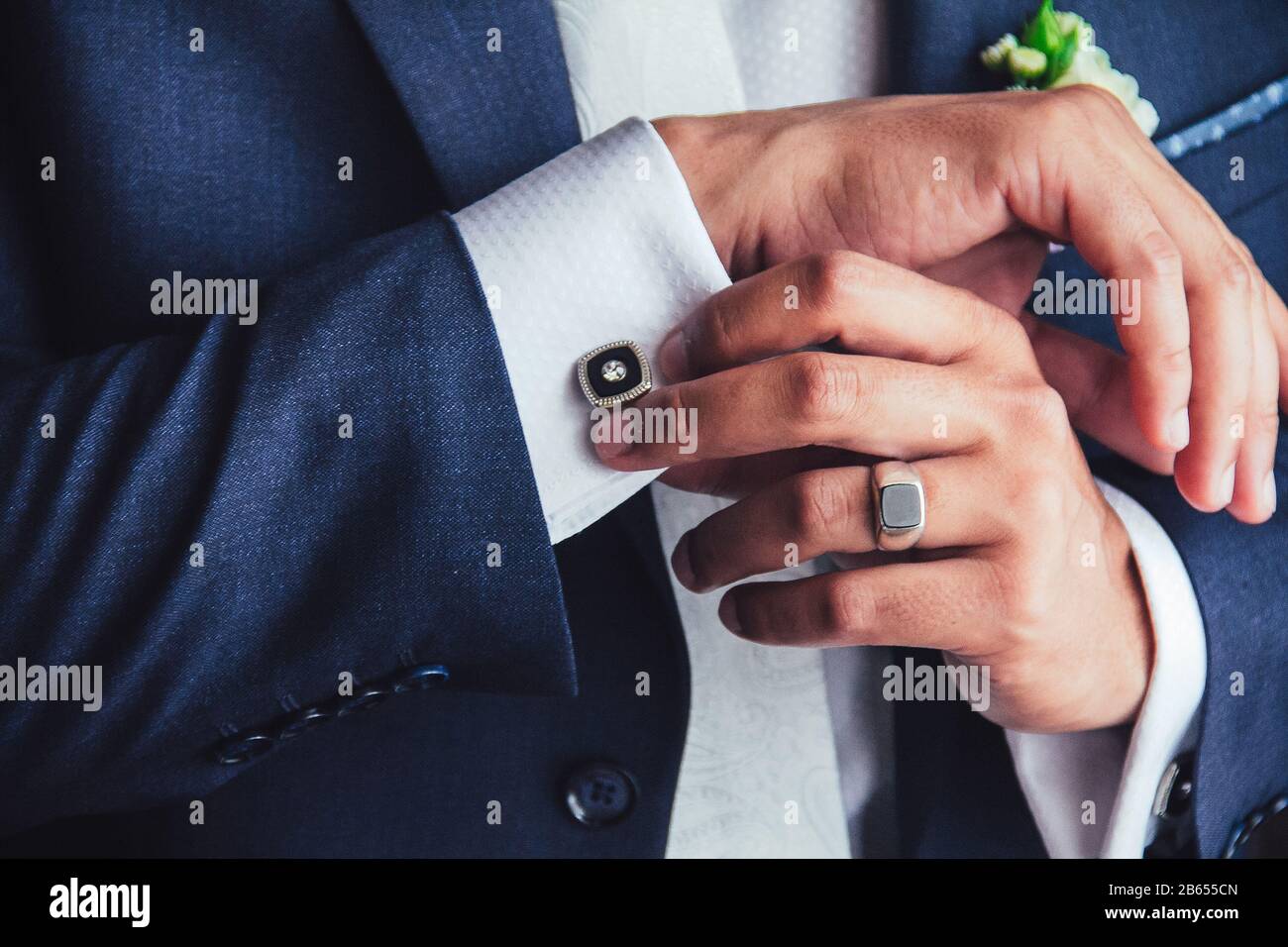 Man fixing cufflinks hi-res stock photography and images - Alamy