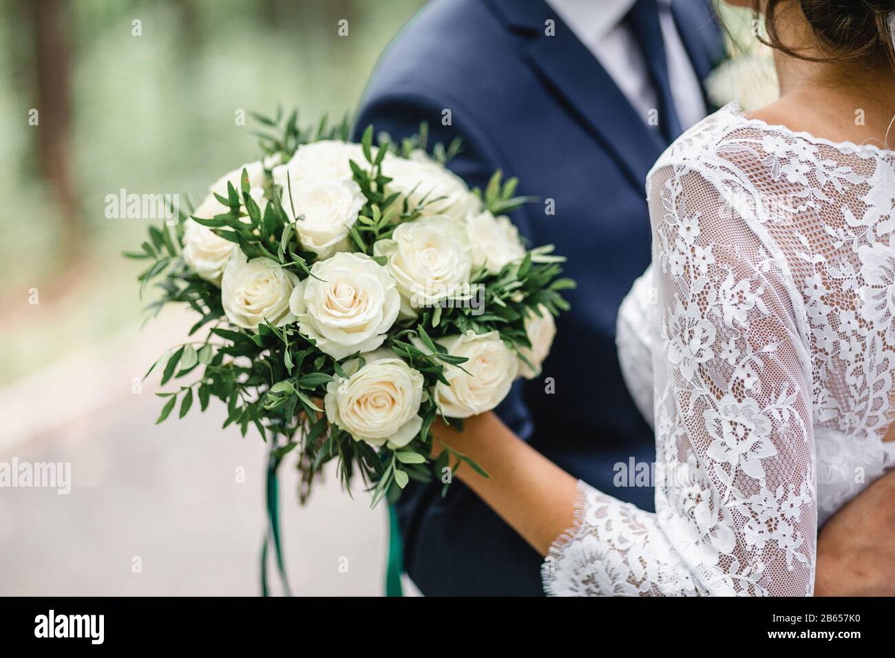 Happy bride and groom on their wedding hugging Stock Photo - Alamy