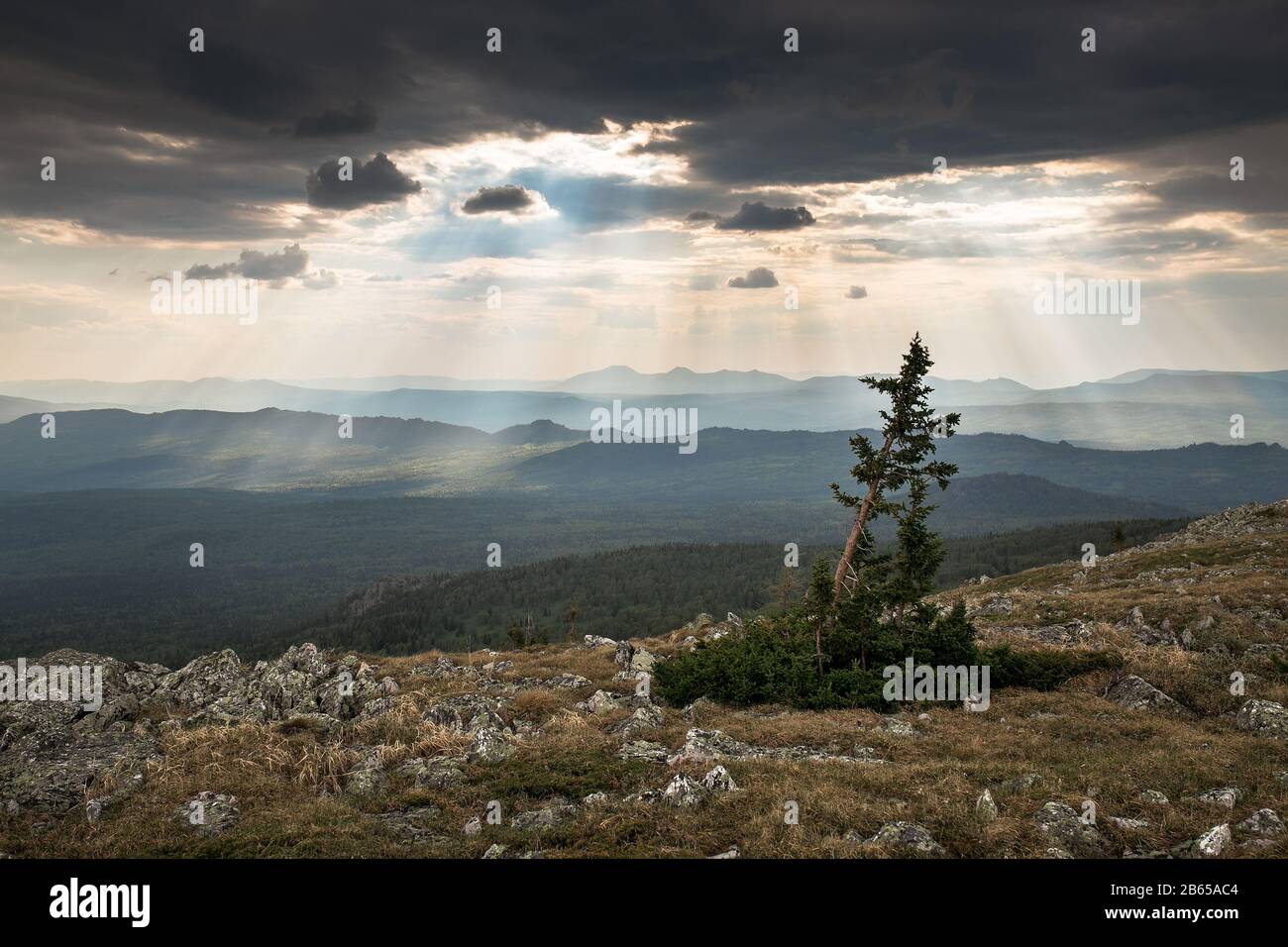 landscape with mountains and hills. sun rays dramatic at background ...