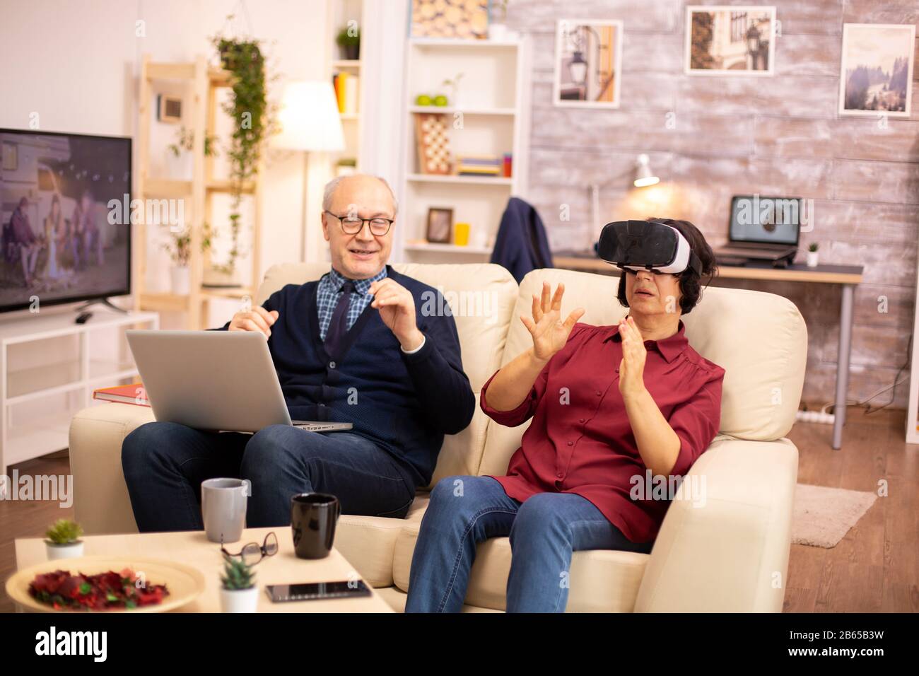 Old elderly retired woman in her 60s experiencing virtual reality for ...