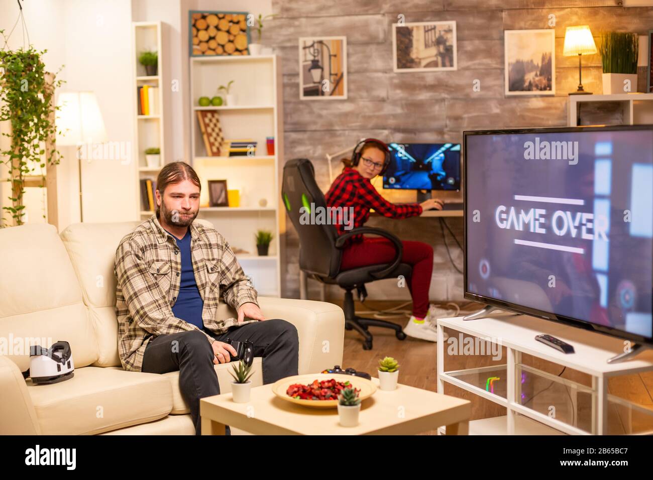 Stressed and angry male gamer losing a game while playing late at night ...