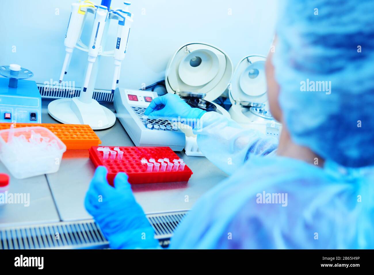 female scientist makes PCR DNA tests in a modern chemical and ...