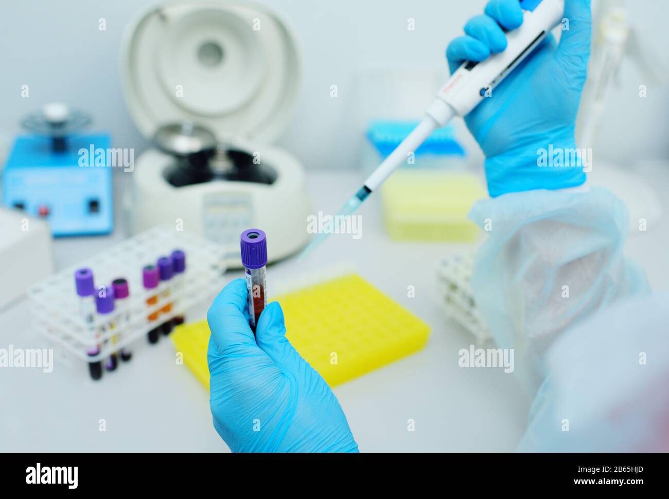 scientist in a medical laboratory with a dispenser in his hands is ...