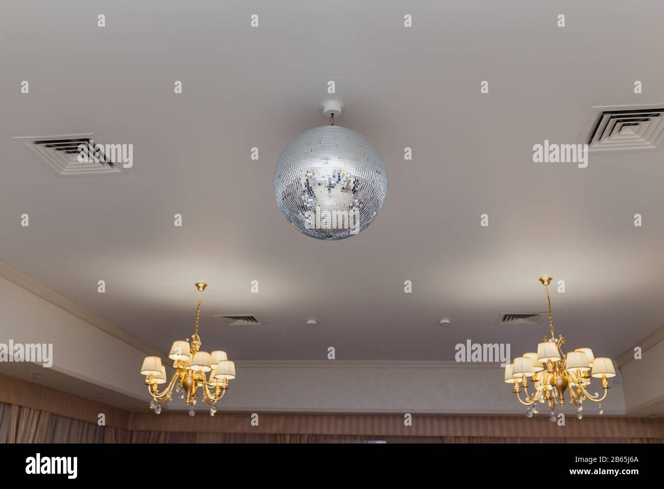 Shining disco ball on the ceiling of the restaurant Stock Photo - Alamy