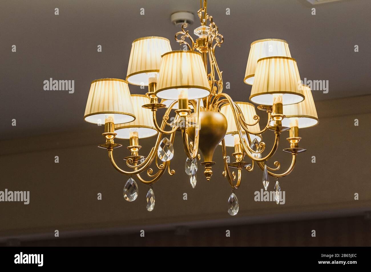 Lighted simple chandelier in small restaurant Stock Photo - Alamy