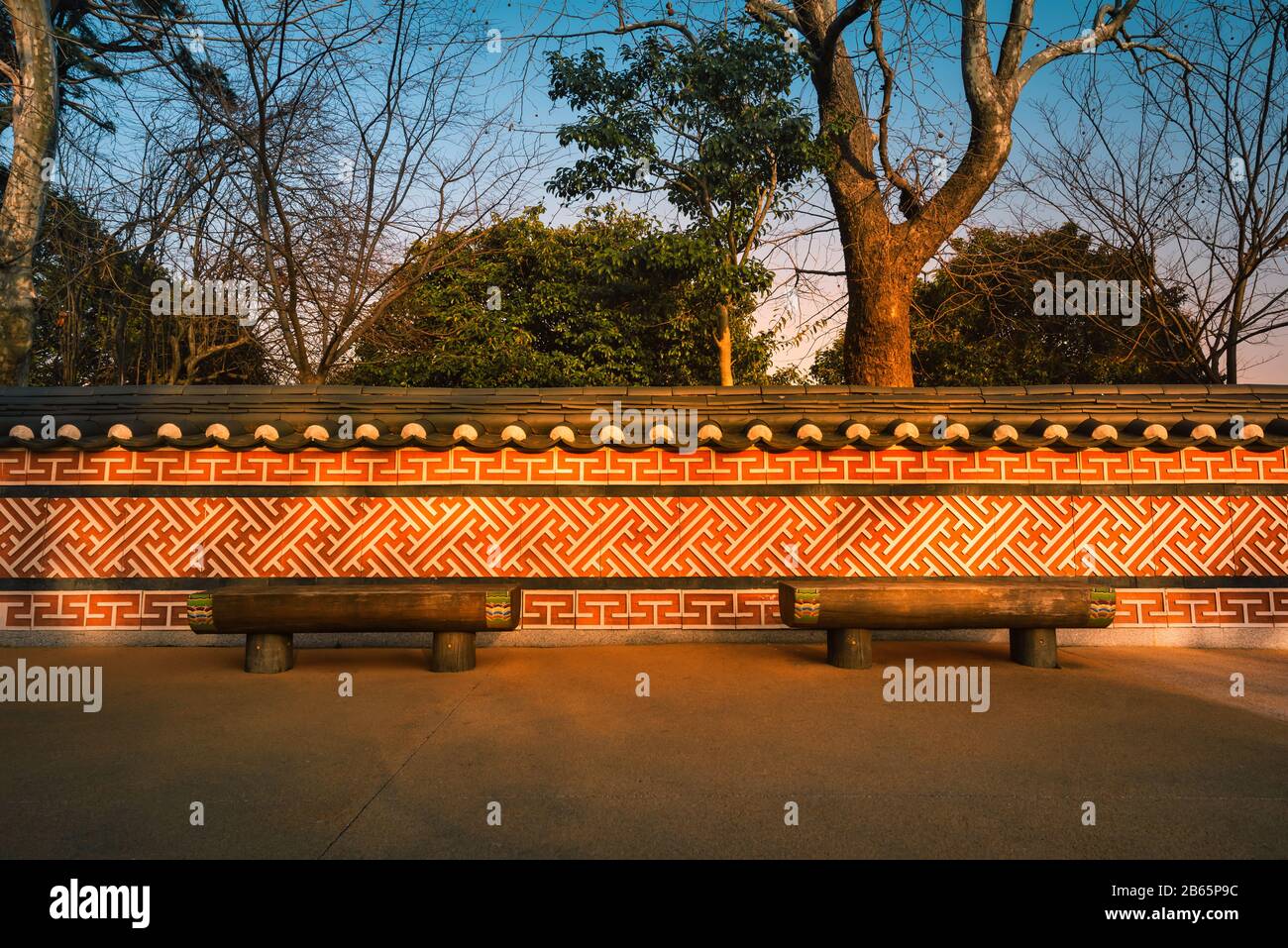 Wooden benches with Korean traditional walls at sunset in South Korea ...