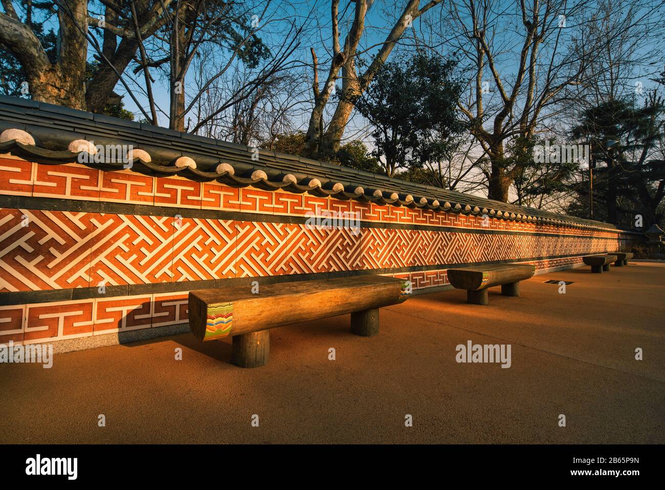 Wooden benches with Korean traditional walls at sunset in South Korea ...